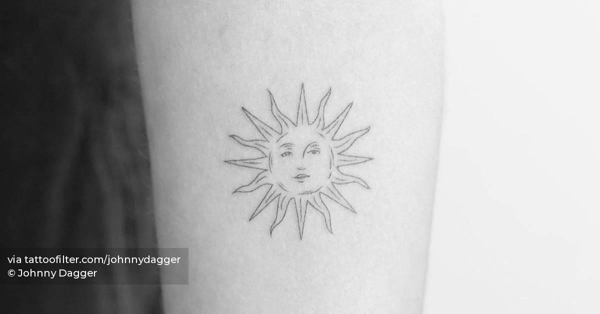 Fine line sun tattoo on the inner forearm.