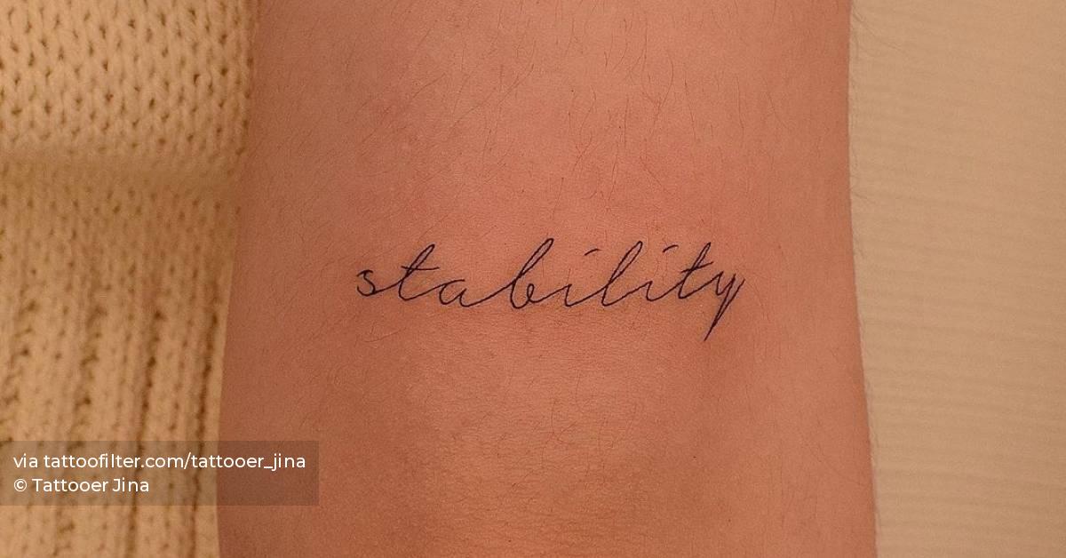 "Stability" lettering tattoo on the tricep.