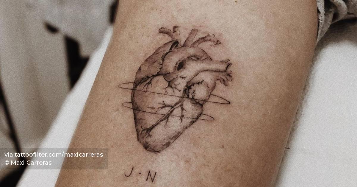 Micro-realistic anatomical heart and initials tattoo on