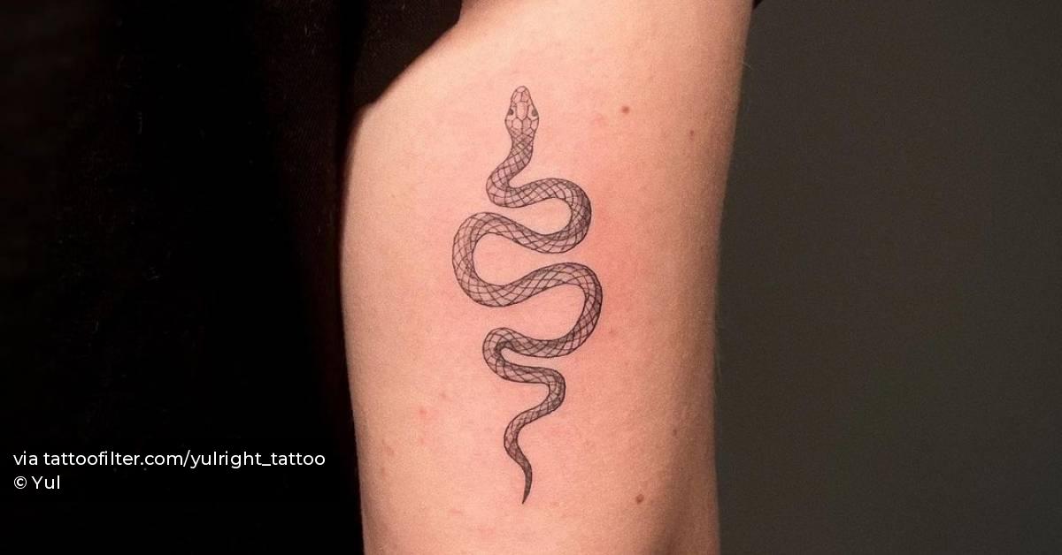 Fine line snake tattoo on the tricep.