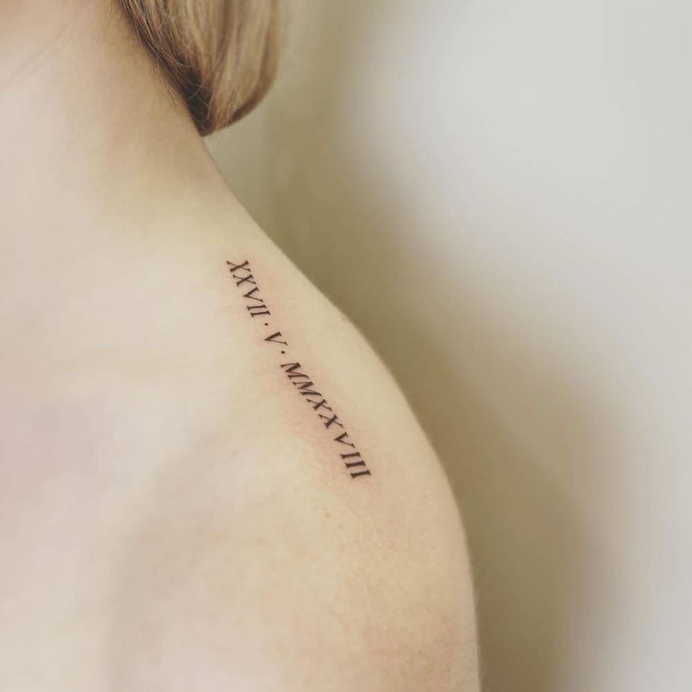 Roman Numerals Tattoo On The Top Of Shoulder 