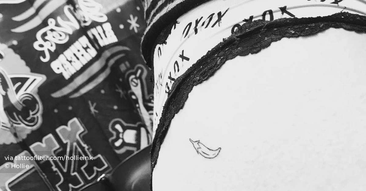 Minimalist chili pepper tattoo on the butt cheek.