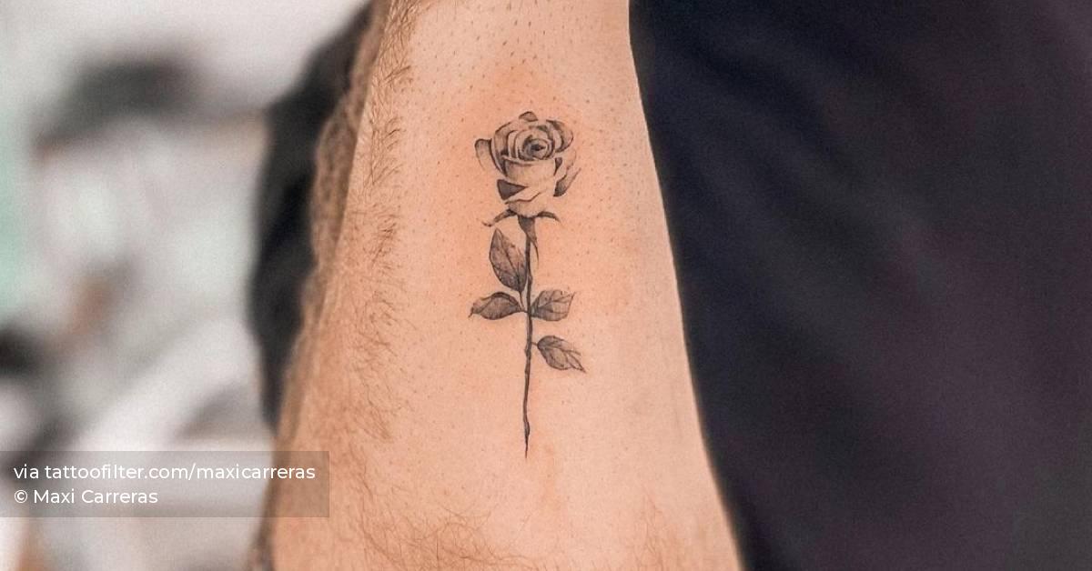 Micro-realistic rose tattoo on the forearm.