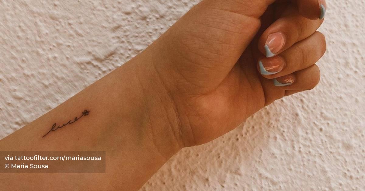 "Luce" lettering tattoo on the wrist.