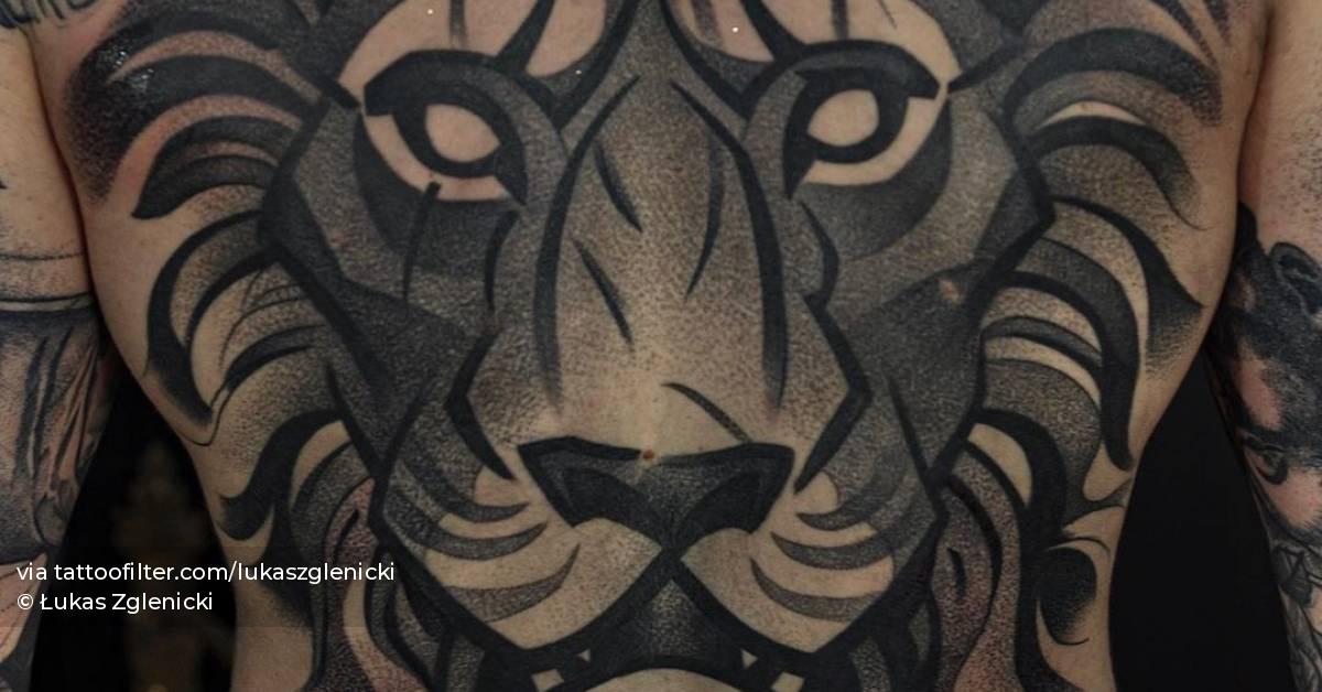 Lion head backpiece tattoo.