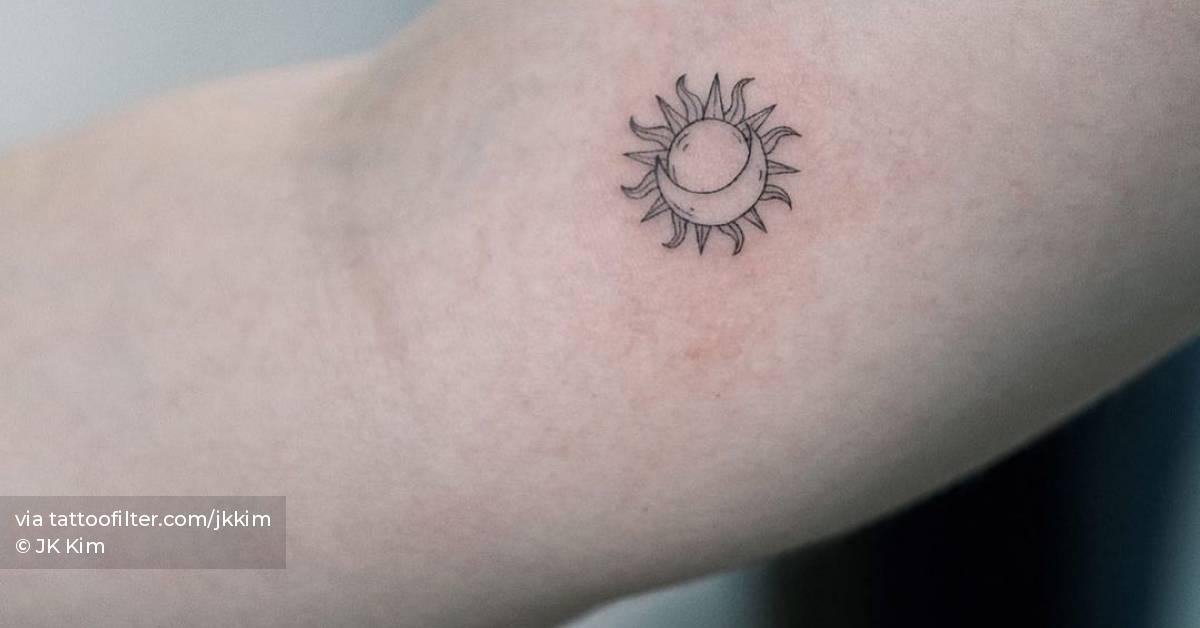 Fine line sun and moon tattoo on the inner arm.