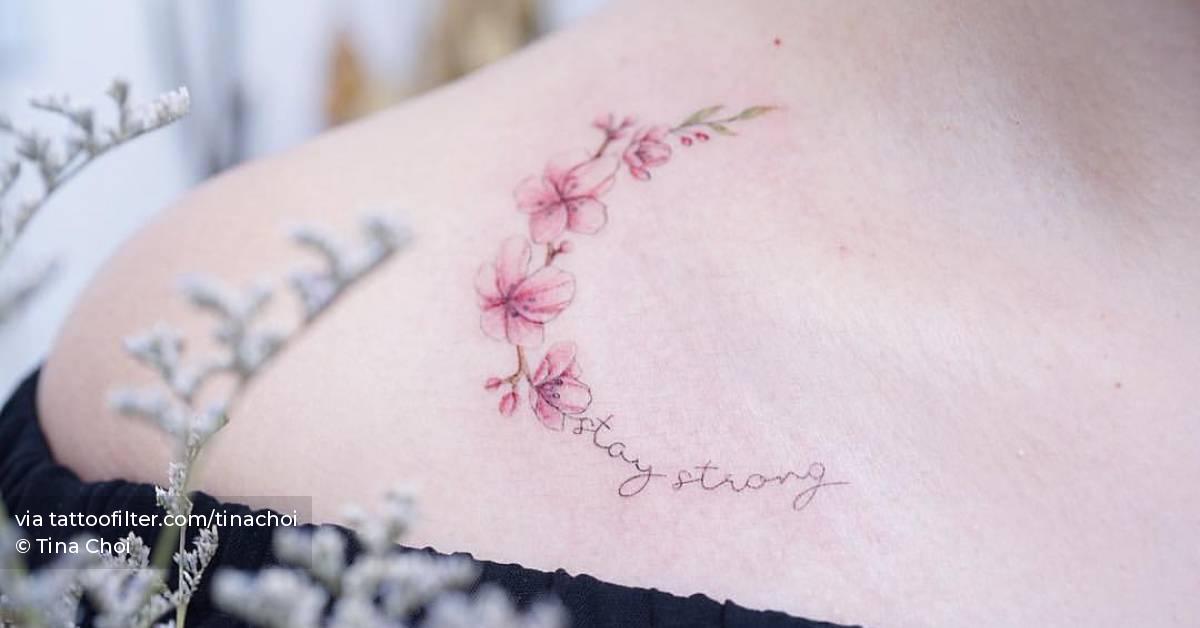 Watercolor flower moon tattoo on the collarbone.