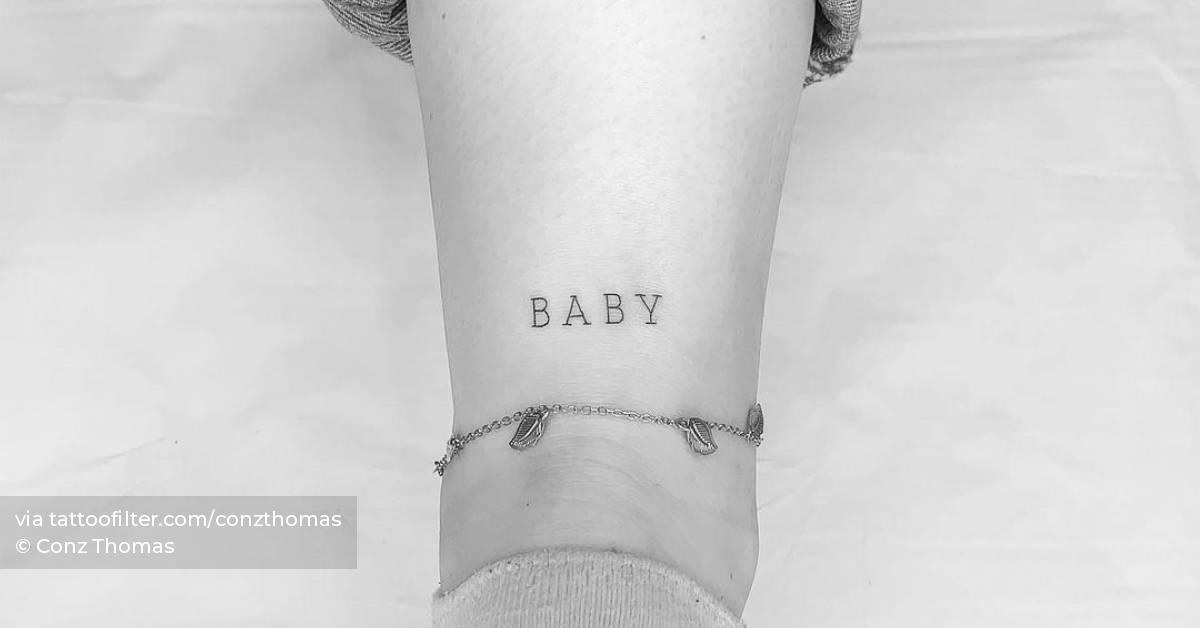 "Baby" lettering tattoo on the achilles.