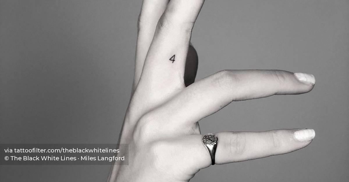 Minimalist number "4" tattoo on the finger.