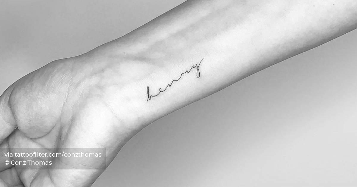 "Henry" lettering tattoo on the wrist.