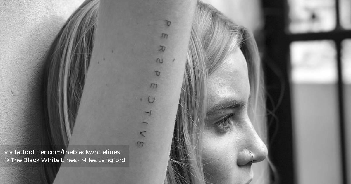 "Perspective" lettering tattoo on the tricep.