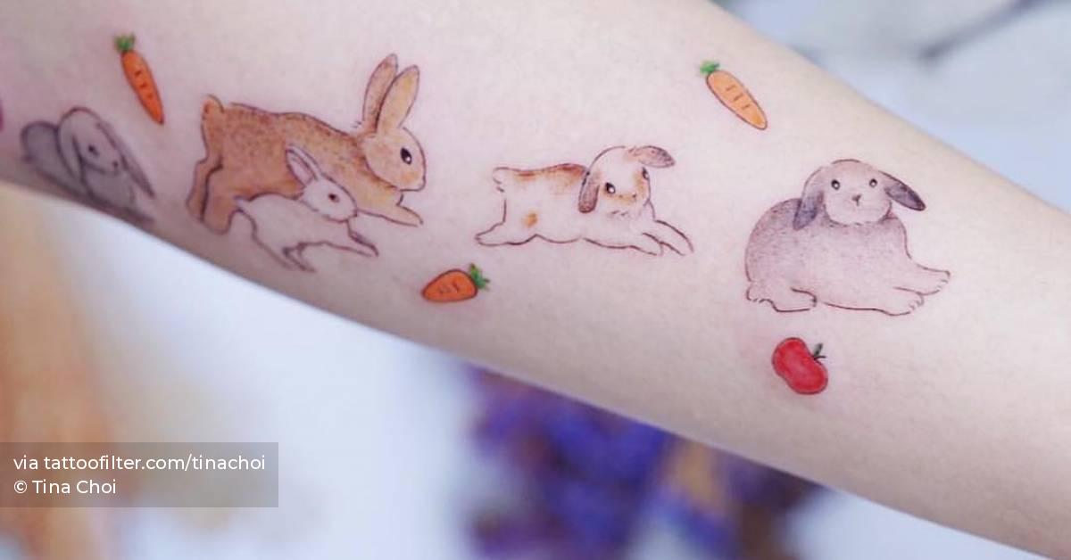 Watercolor rabbits tattoo on the forearm.