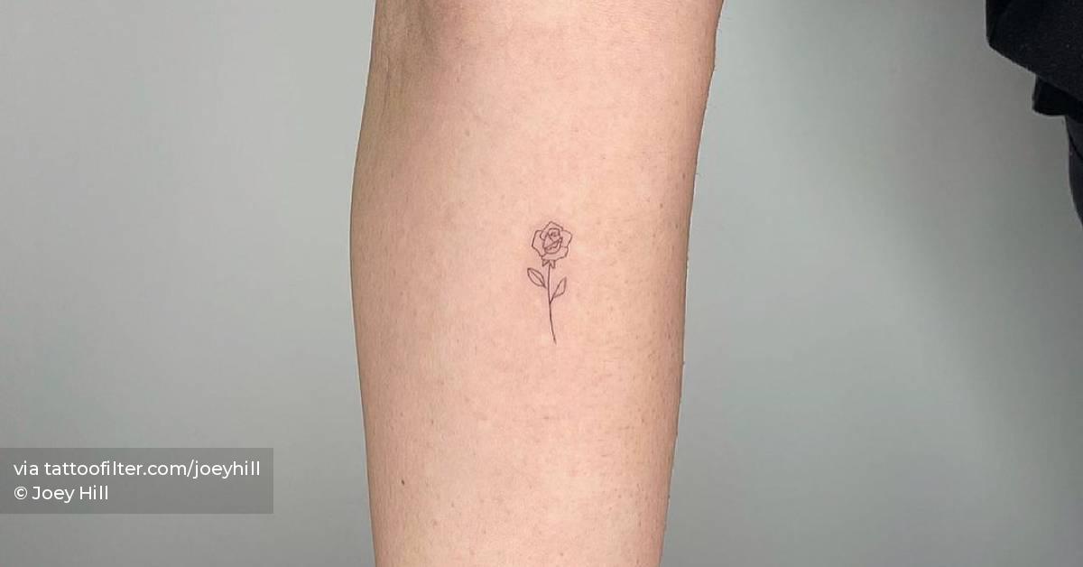 Fine line rose tattoo on the inner forearm.
