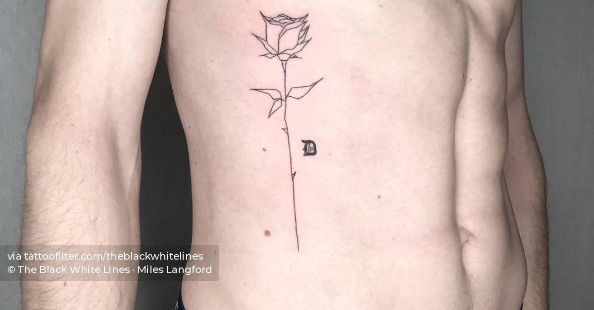 Line art rose tattoo on the rib.