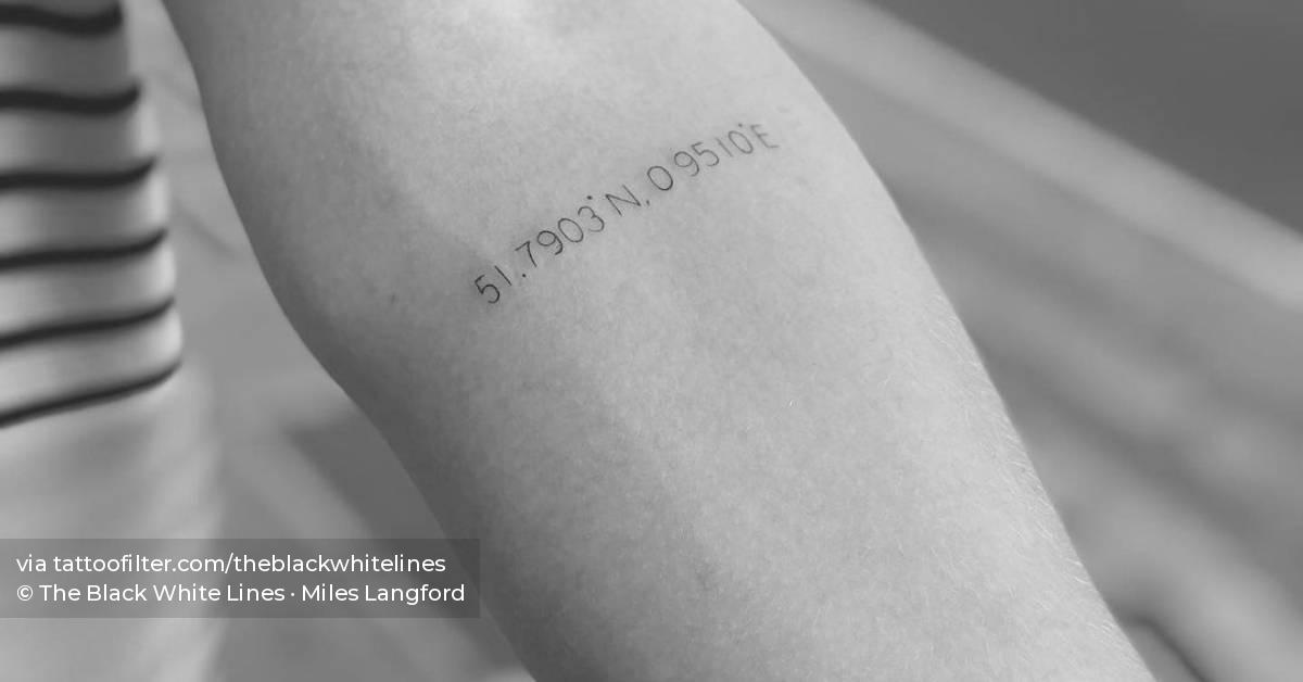 Coordinates lettering tattoo on the inner forearm.