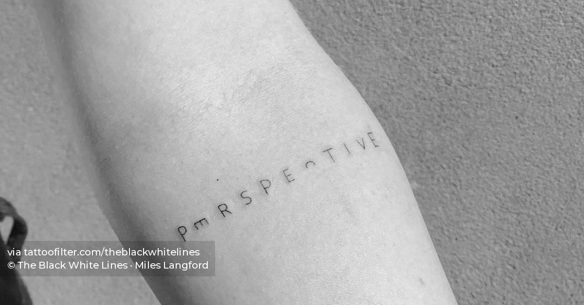 "Perspective" lettering tattoo on the inner forearm.
