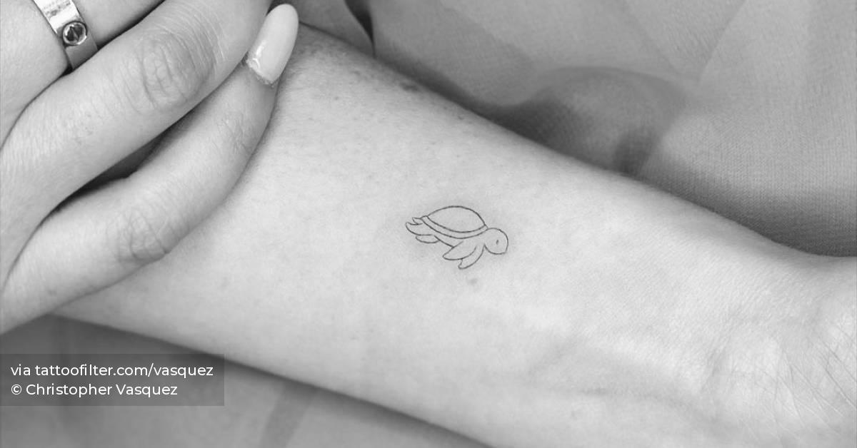 Fine line turtle tattoo on the wrist.