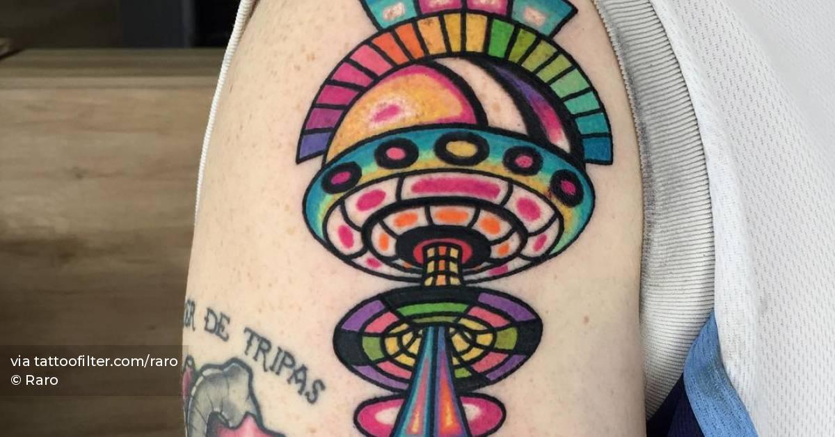 Pop art UFO tattoo on the upper arm.