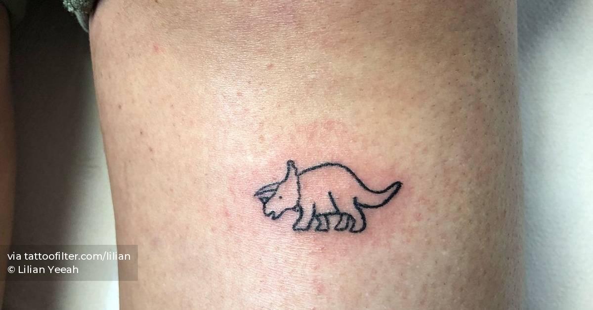 Hand poked triceratops tattoo on the shin.
