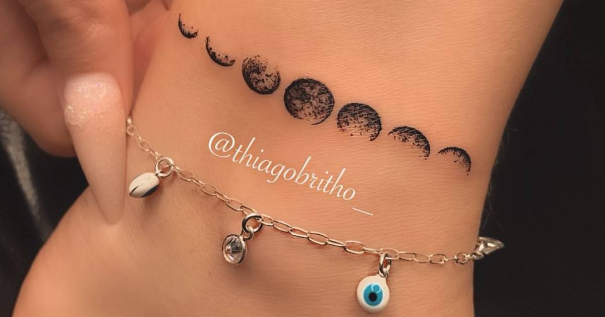 Moon phases tattoo on the ankle.