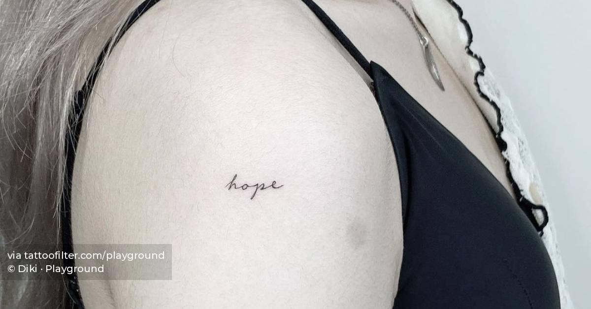 "Hope" lettering tattoo on the upper arm.