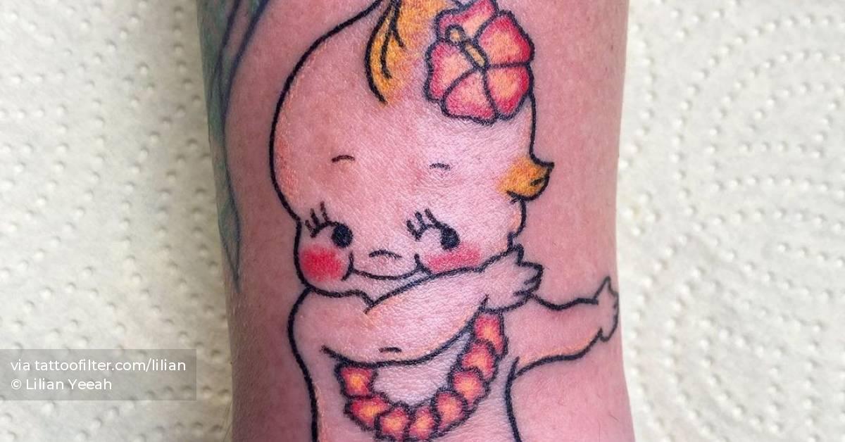 Hand poked Kewpie tattoo on the wrist.