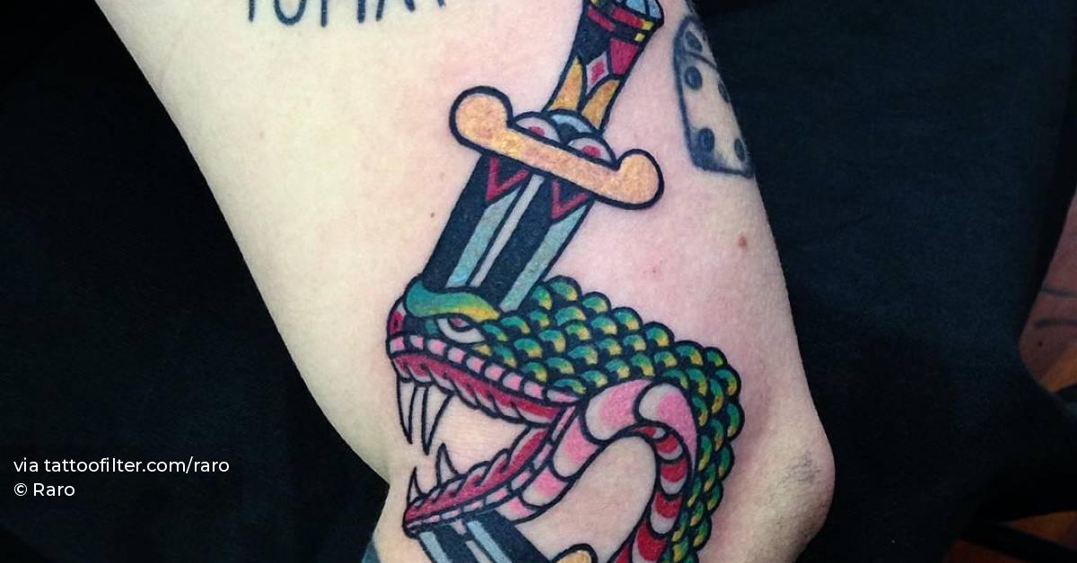 Traditional style snake and dagger tattoo on the elbow.