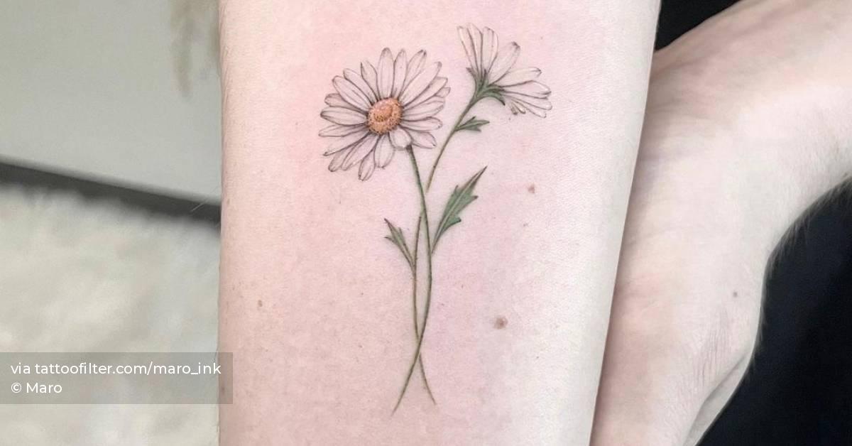 Micro-realistic daisy flower tattoo on the inner
