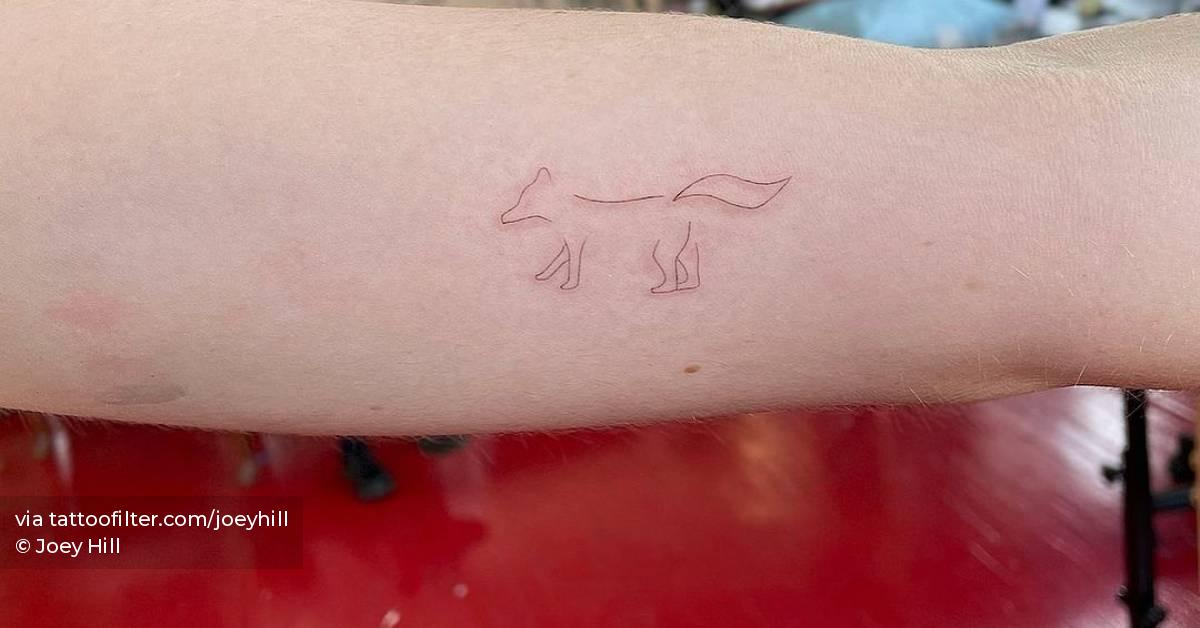 Minimalist fox tattoo on the inner arm.