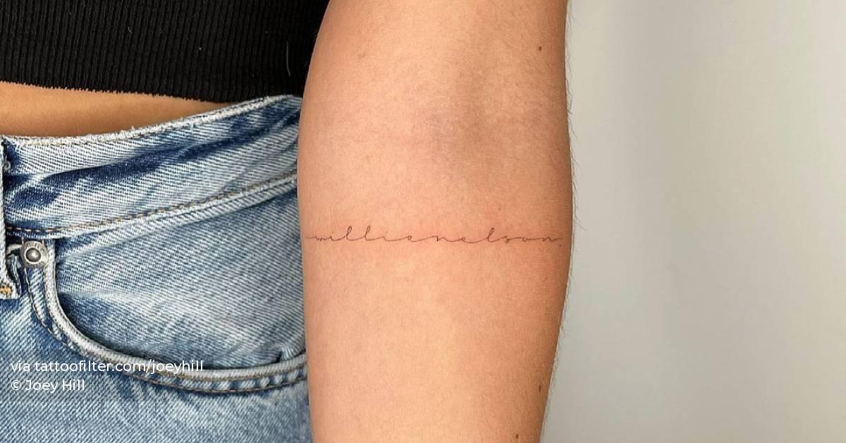 Lettering tattoo on the inner forearm.