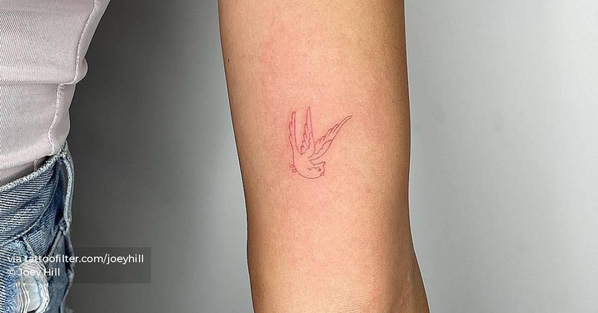 Fine line bird tattoo on the inner arm.
