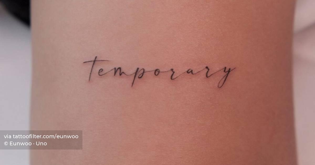 "Temporary" lettering tattoo on the tricep.