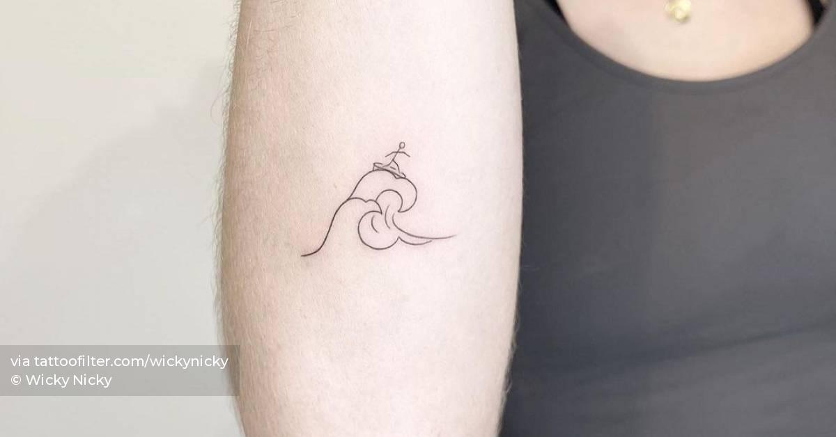 Minimalist surfer tattoo on the forearm.