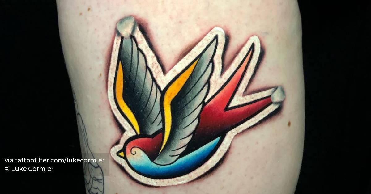 Swallow sticker tattoo on the inner arm.