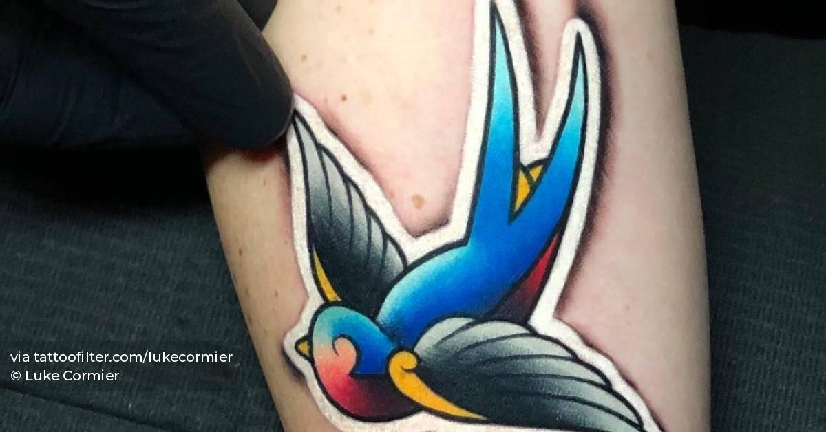 Swallow sticker tattoo on the inner forearm.