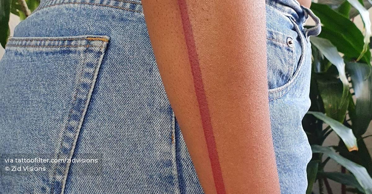Bold red ink stripe. Handpoke Tattoo made in Berlin.