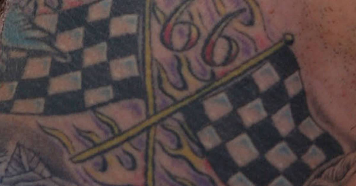 Racing flags tattoo on Travis Barker's neck.