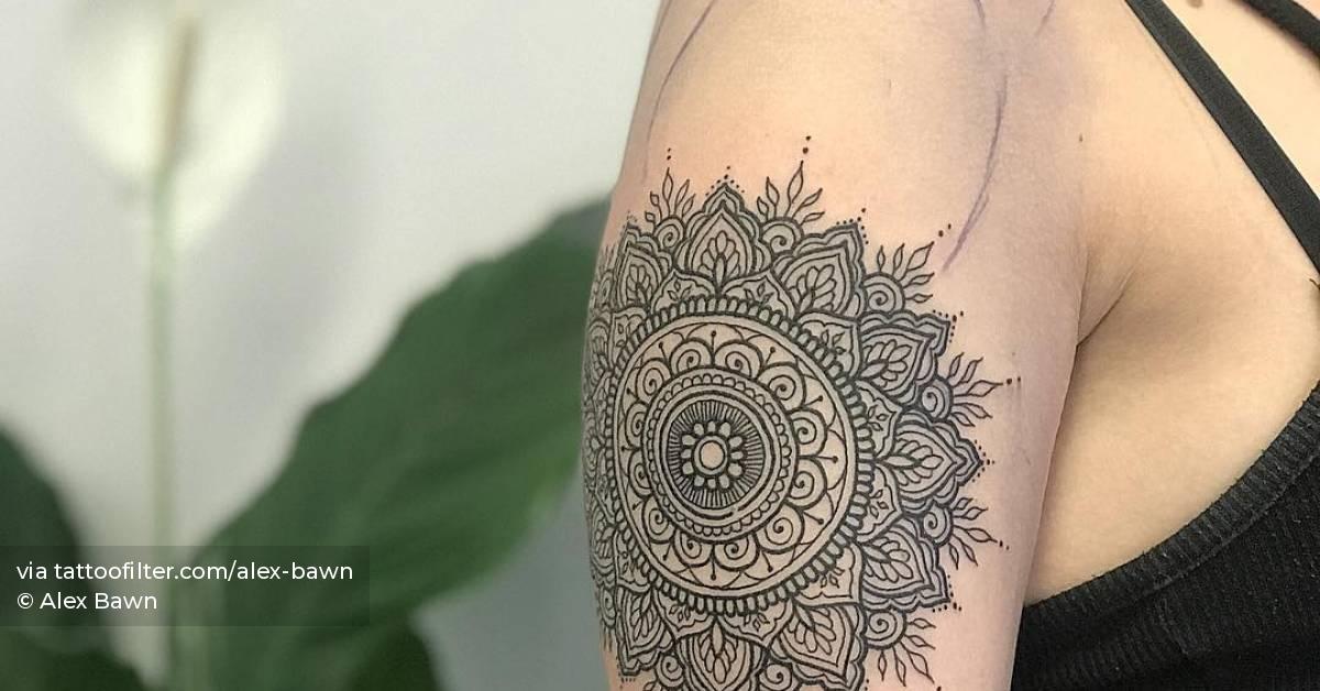 Mandala tattoo on the upper arm.