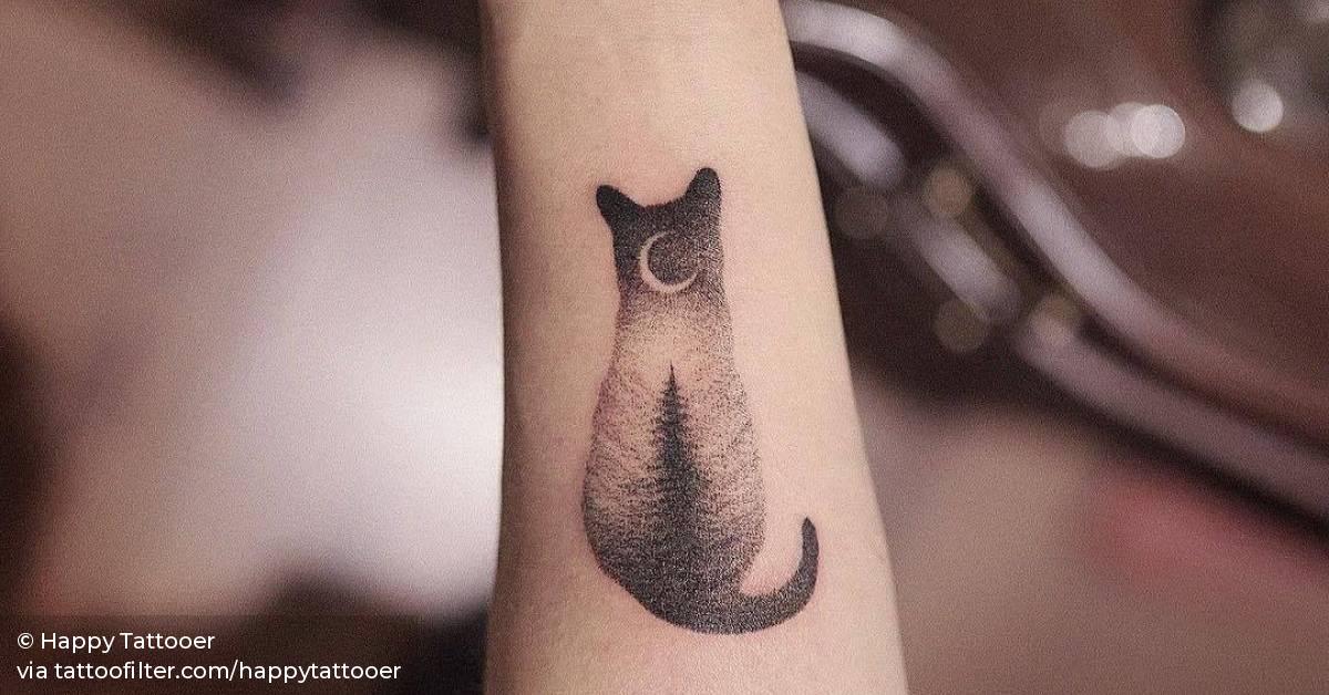 Double exposure cat tattoo on the inner forearm.
