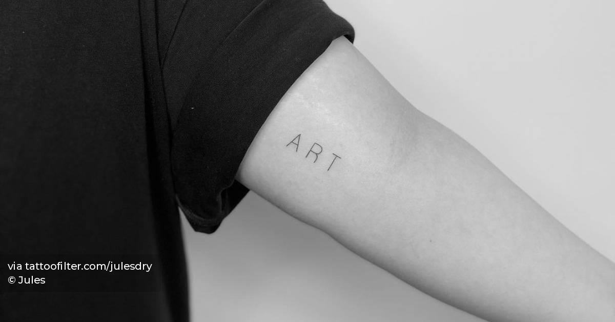 "Art" lettering tattoo on the inner arm.