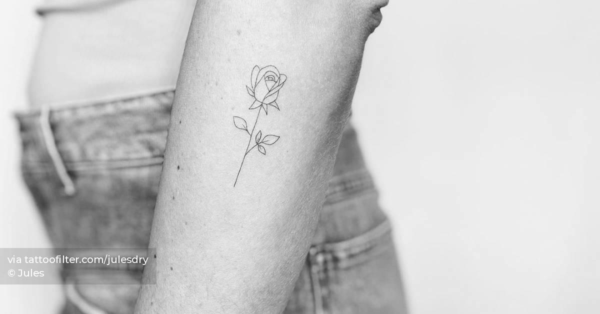 Fine line rose tattoo on the forearm.