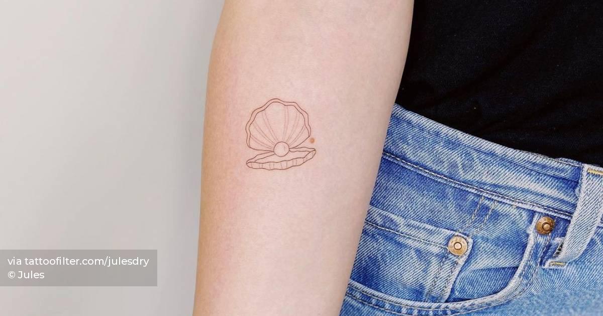 FIne line seashell tattoo on the inner forearm.
