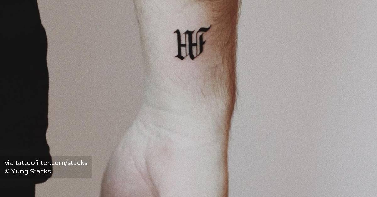 Letter "W" tattoo on the wrist.