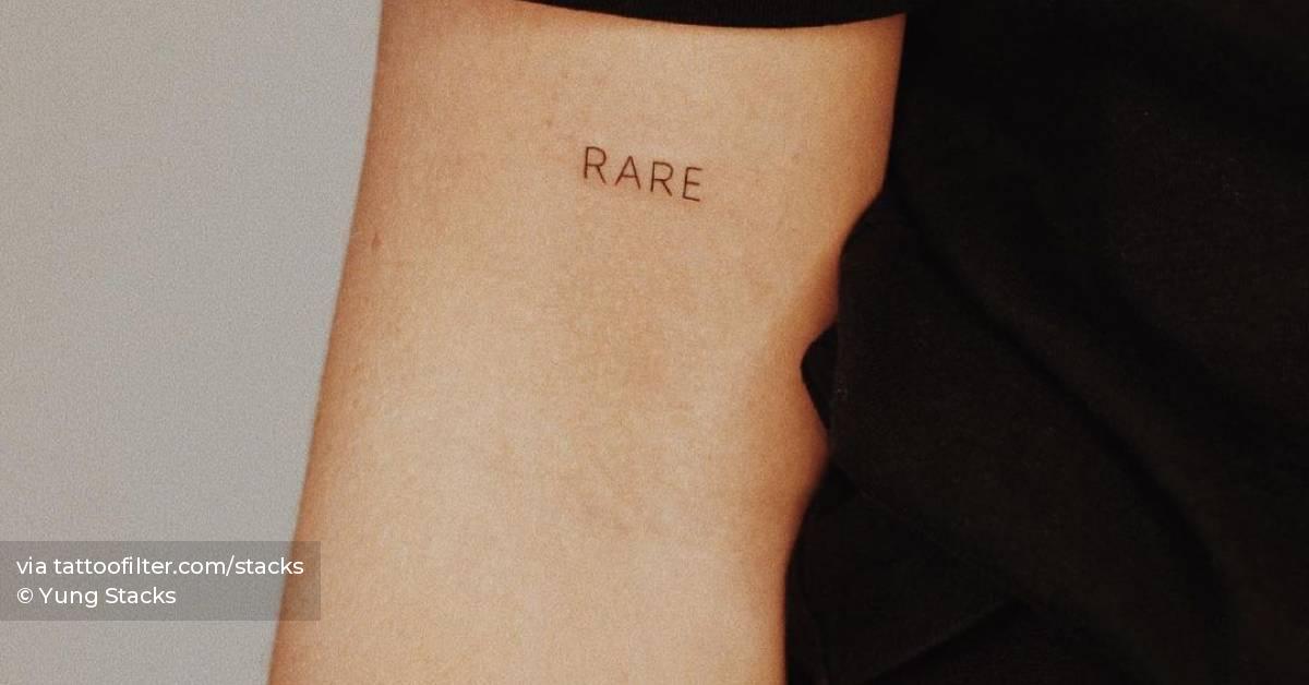 "Rare" lettering tattoo on the bicep.