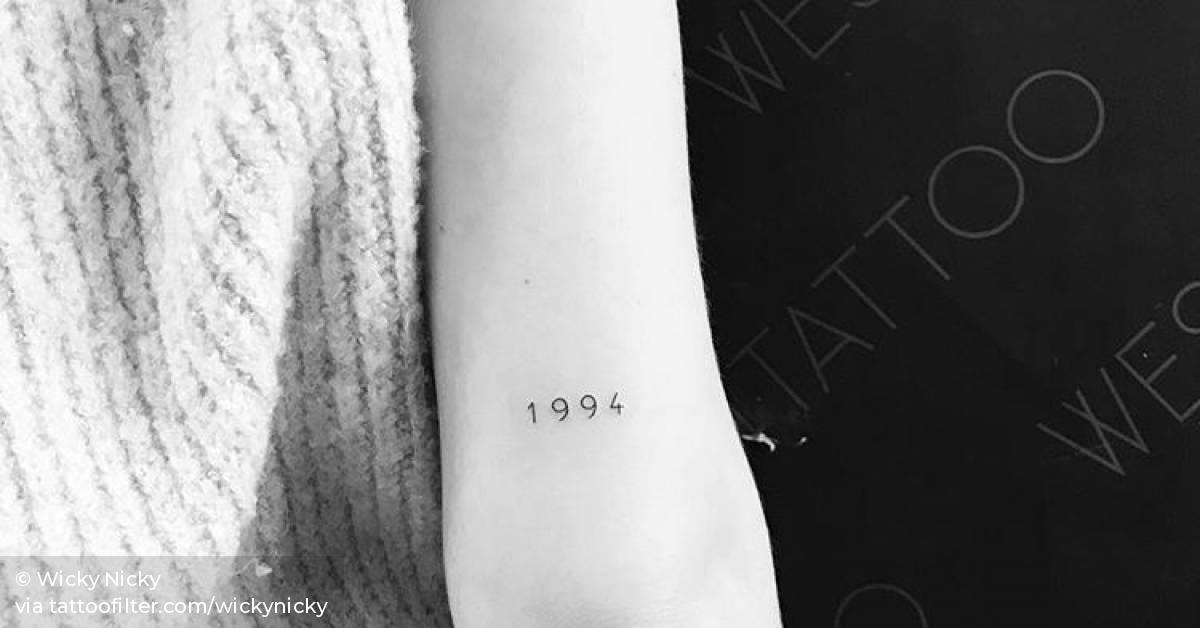 “1994” tattoo on the back of the right arm.