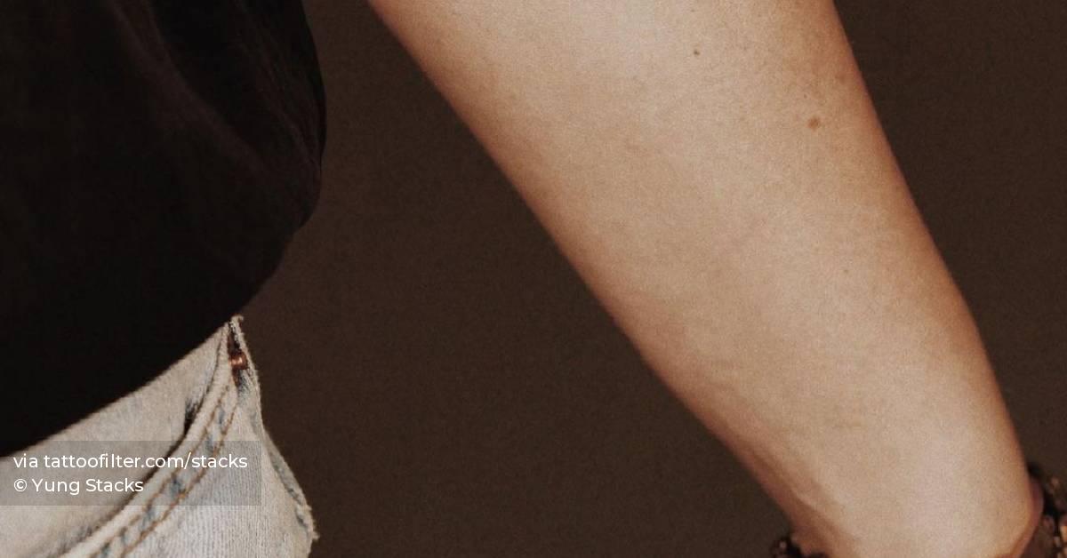 "Eunoia" lettering tattoo on the inner forearm.