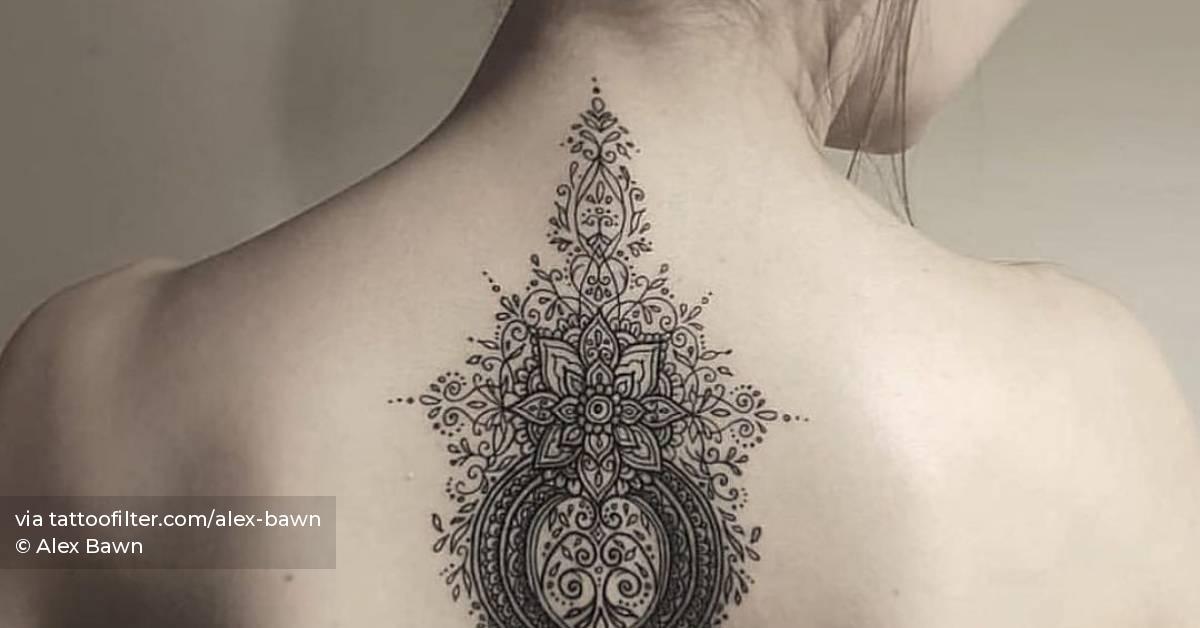 Henna design tattoo on the upper back.
