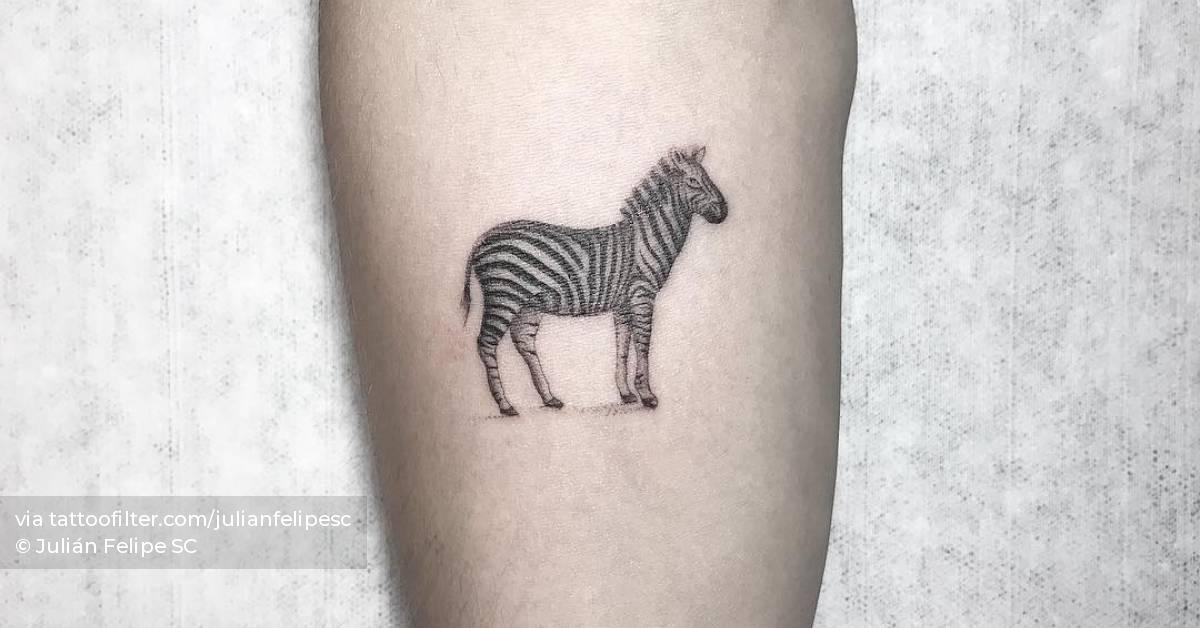Micro-realistic zebra tattoo on the inner forearm.