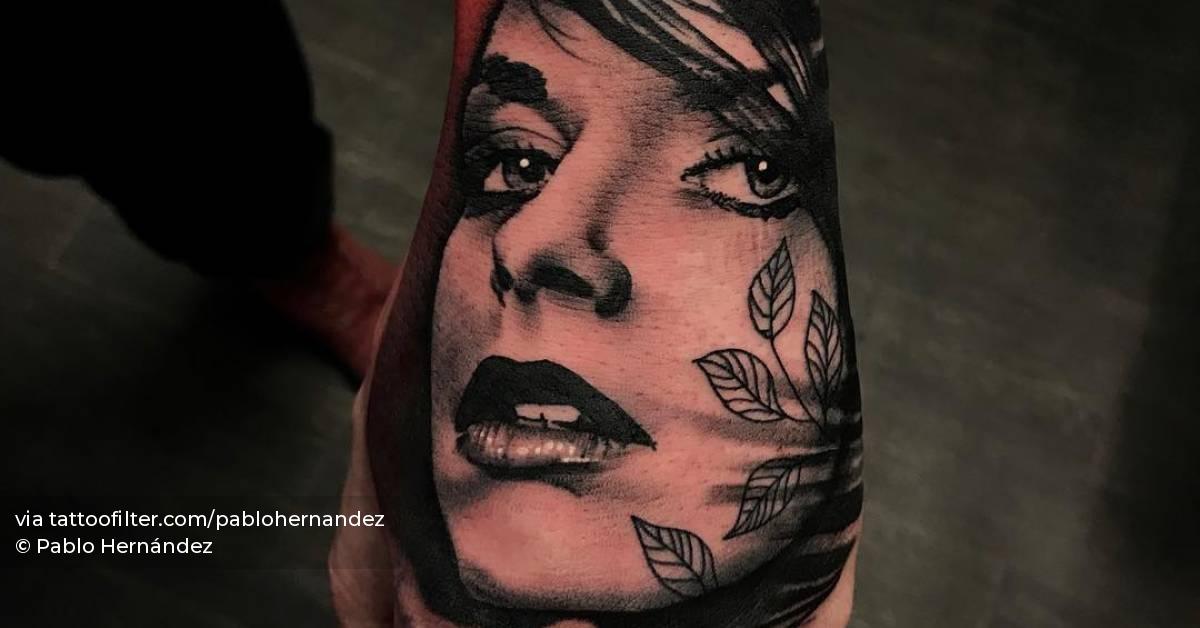 Woman portrait tattoo on the hand.