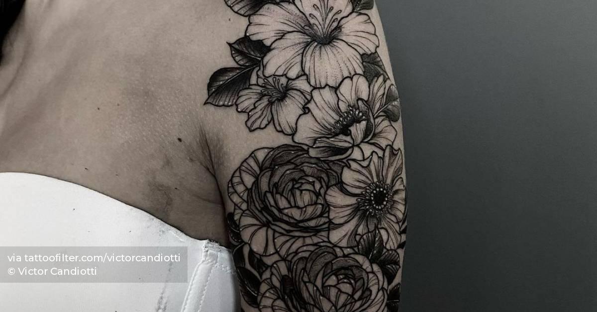 Blackwork flowers tattoo on the upper arm.